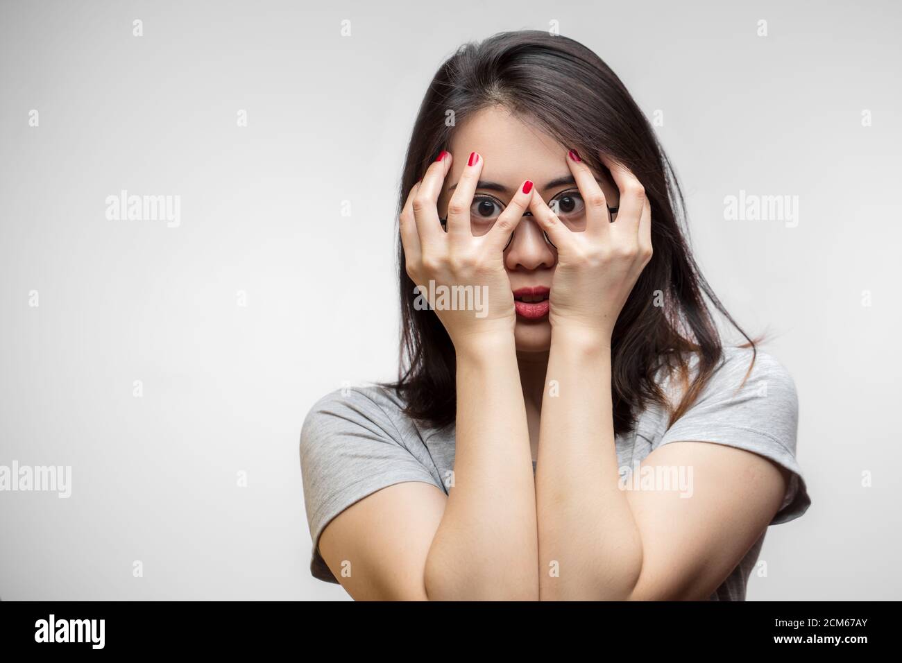 Shocked panic young Asian woman hiding face with hands, being ...