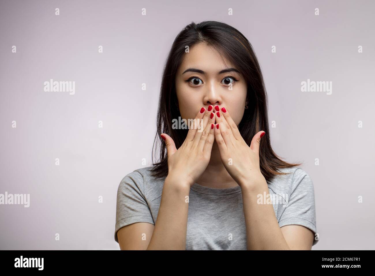 Beautiful Asian young woman with frightened face expression cover Woman ...