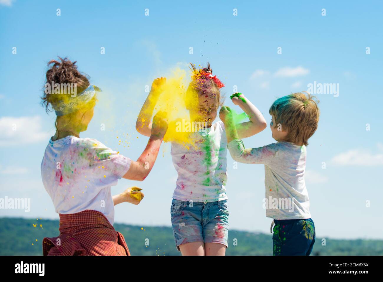 Bright summer colors. Group of children enjoying playing with colored ...