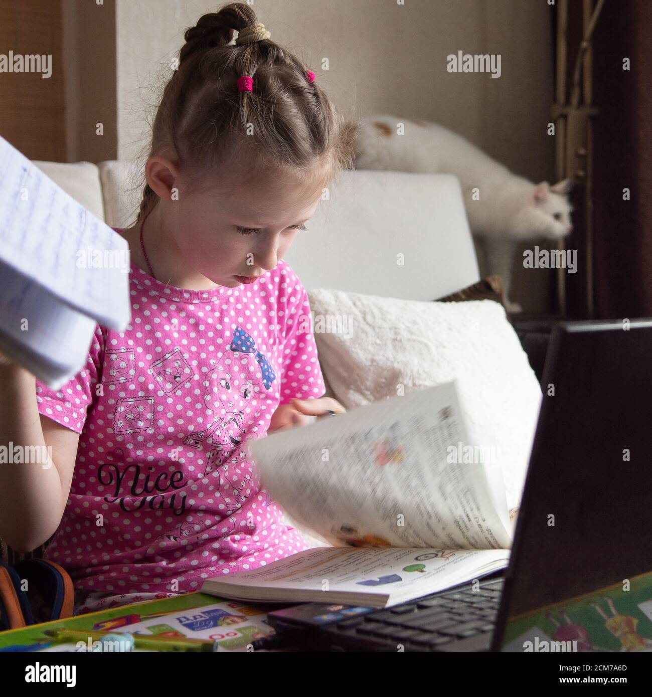 Distance learning online education. Schoolgirl studying at home with ...