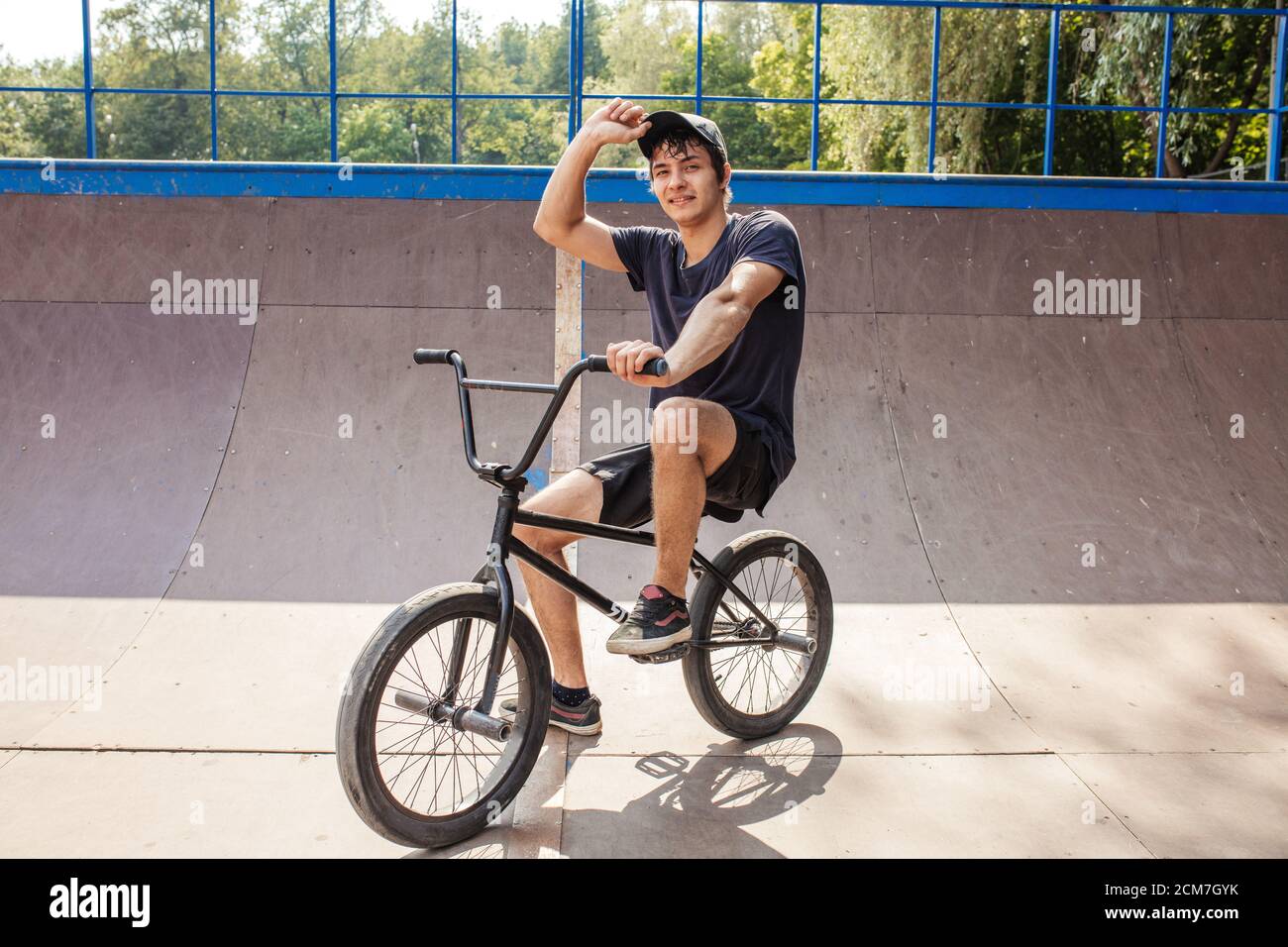 Rider resting on bmx, sitting on cycle in skate park Stock Photo - Alamy
