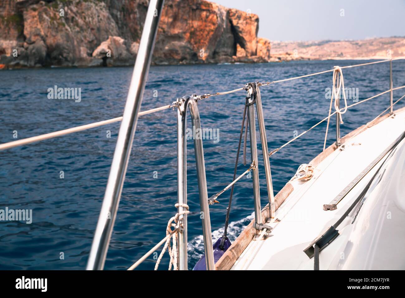 Sailing yacht deck with railings and ropes. Boat trip at sunny summer ...