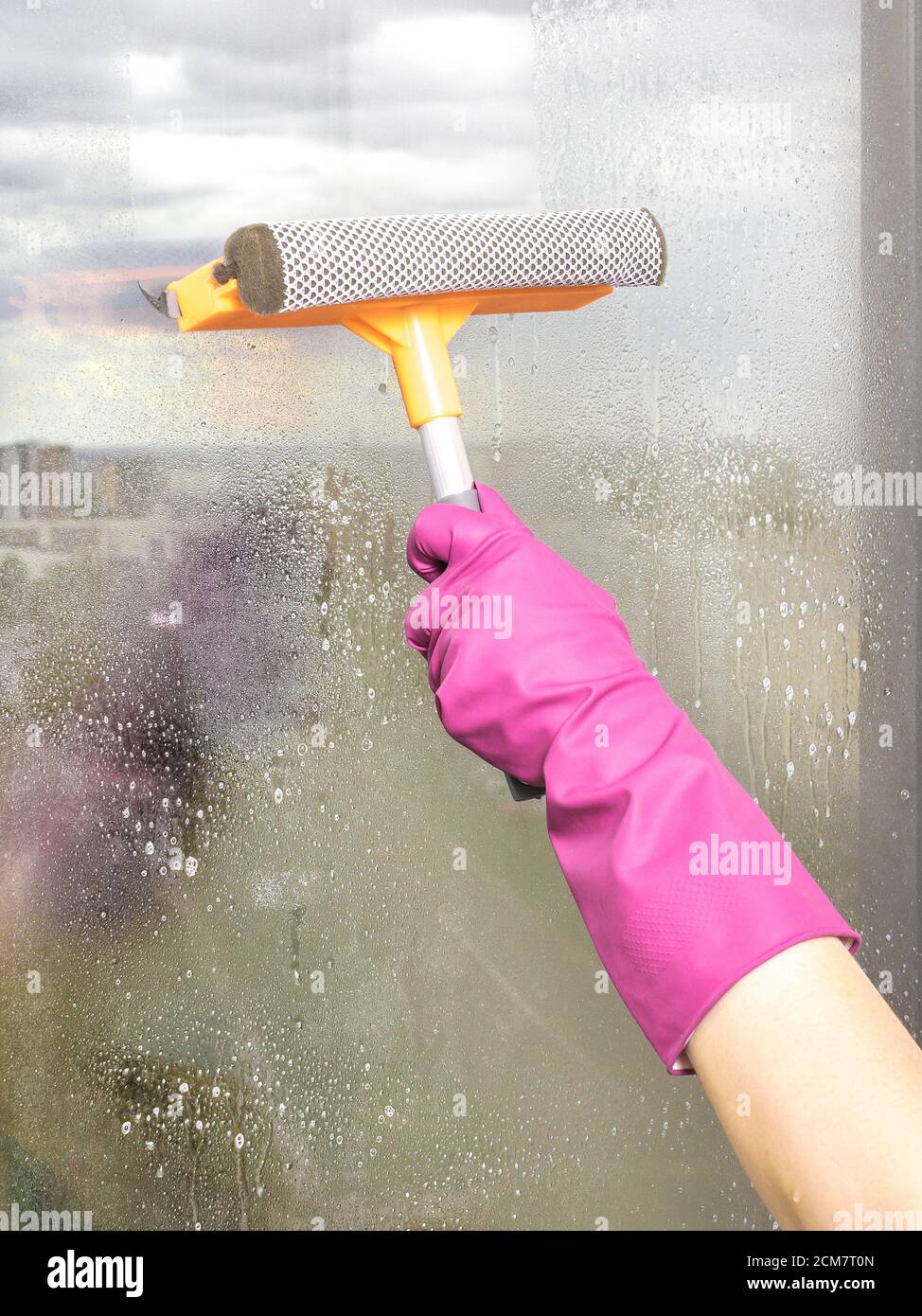 Washing window with soap and foam, closeup. cleaning window at home ...
