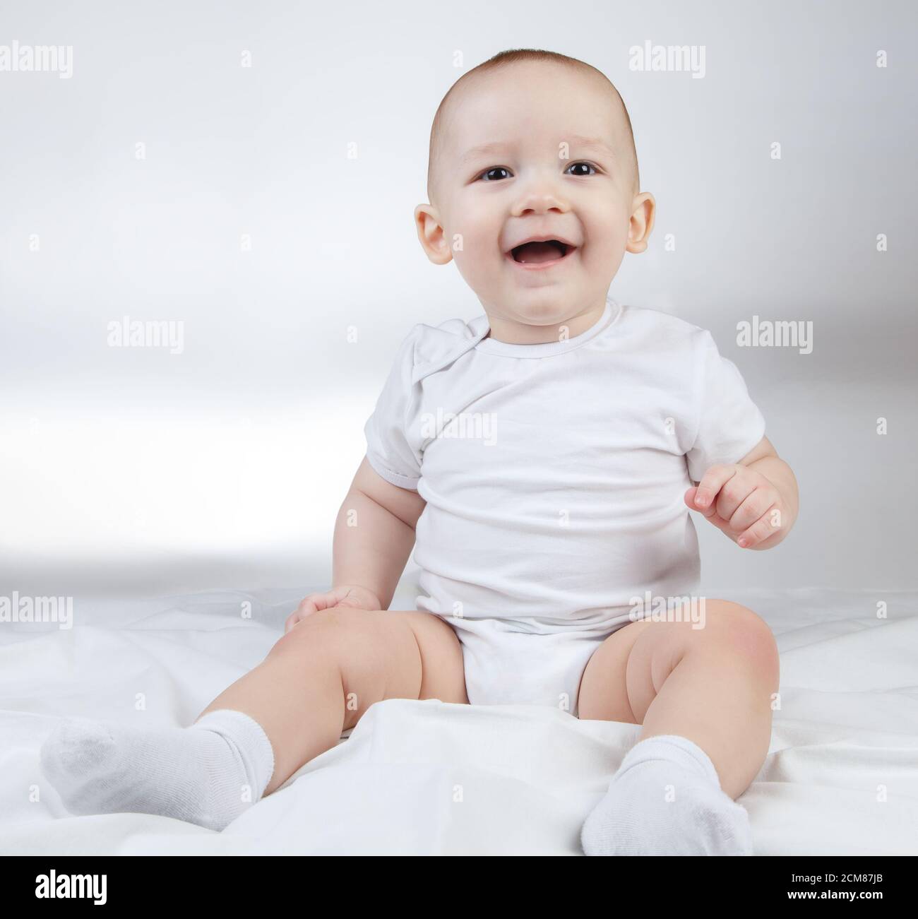 Image of a ten-month-old smiling baby on a white background Stock Photo ...