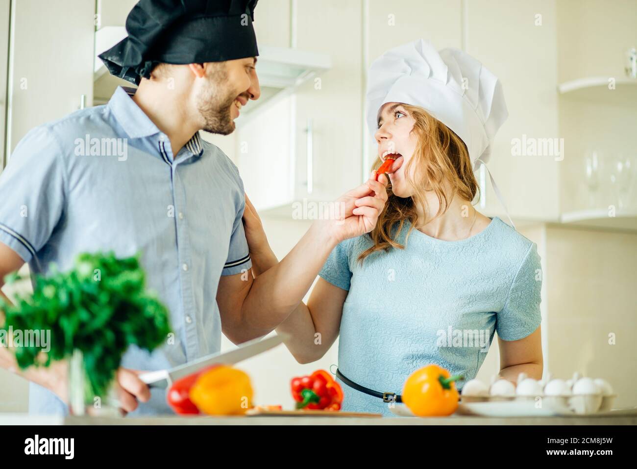 Lovely couple in the kitchen having fun Stock Photo - Alamy