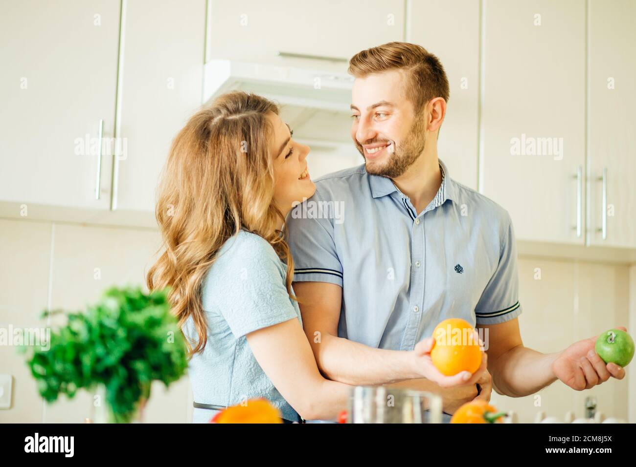 Lovely couple in the kitchen having fun Stock Photo - Alamy