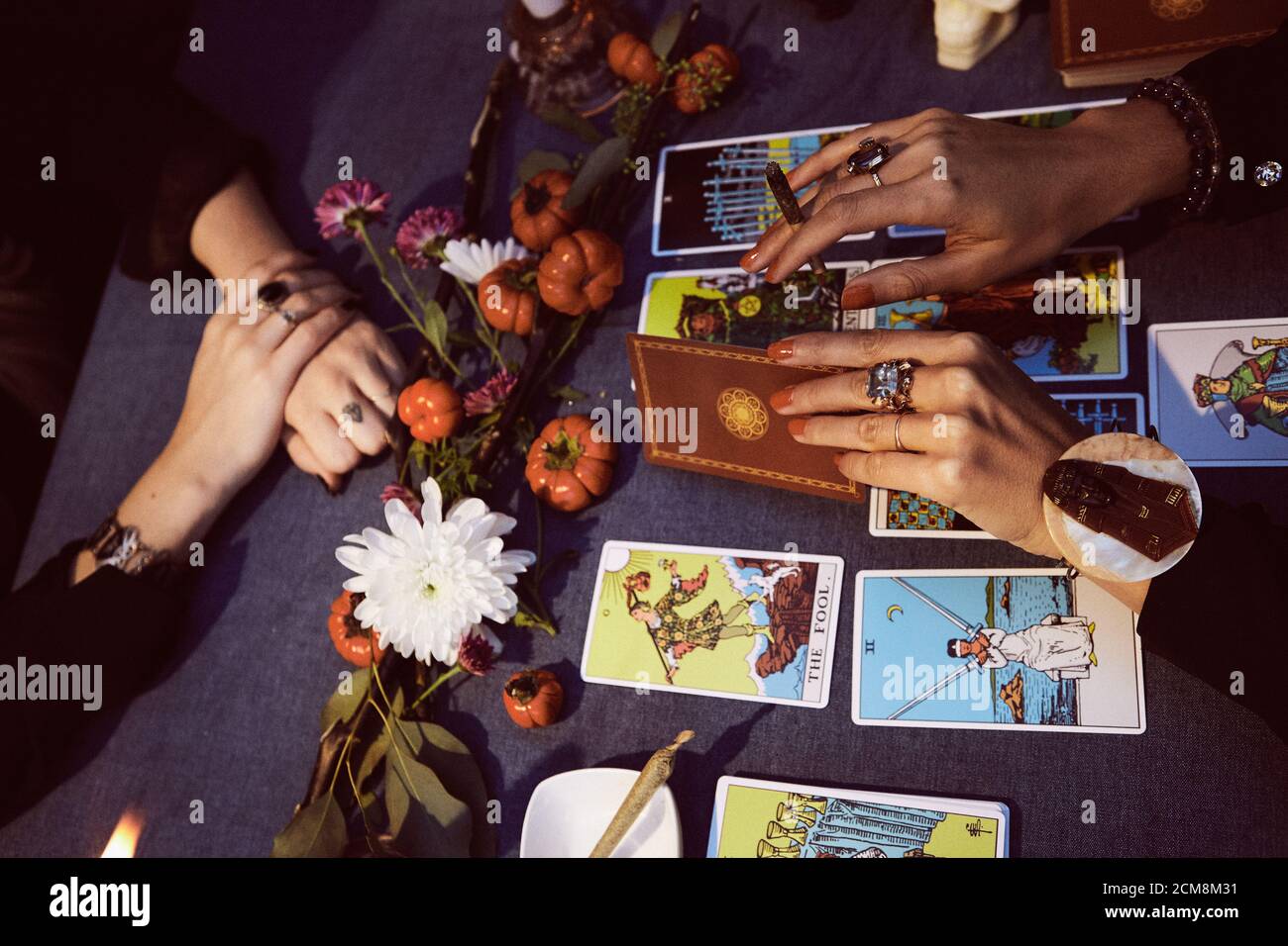 High angle shot of the witches smoking cannabis joint during Tarot Card ...