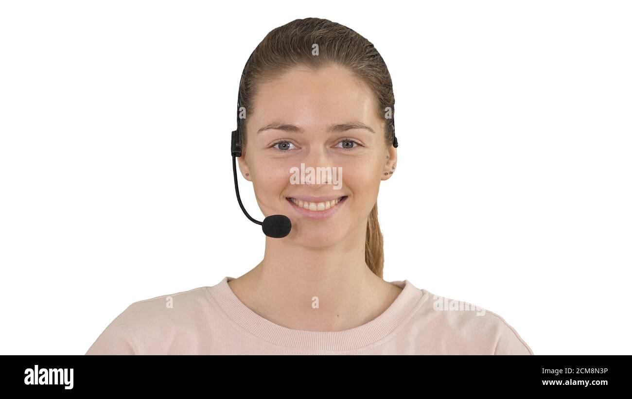 Pretty female support center operator with headset smiling to camera on ...