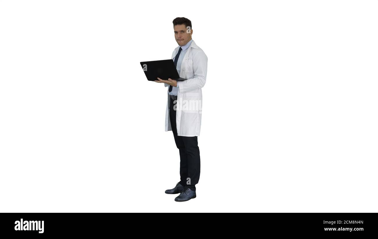 Cheerfull doctor with laptop laughing after giving a serious look to ...