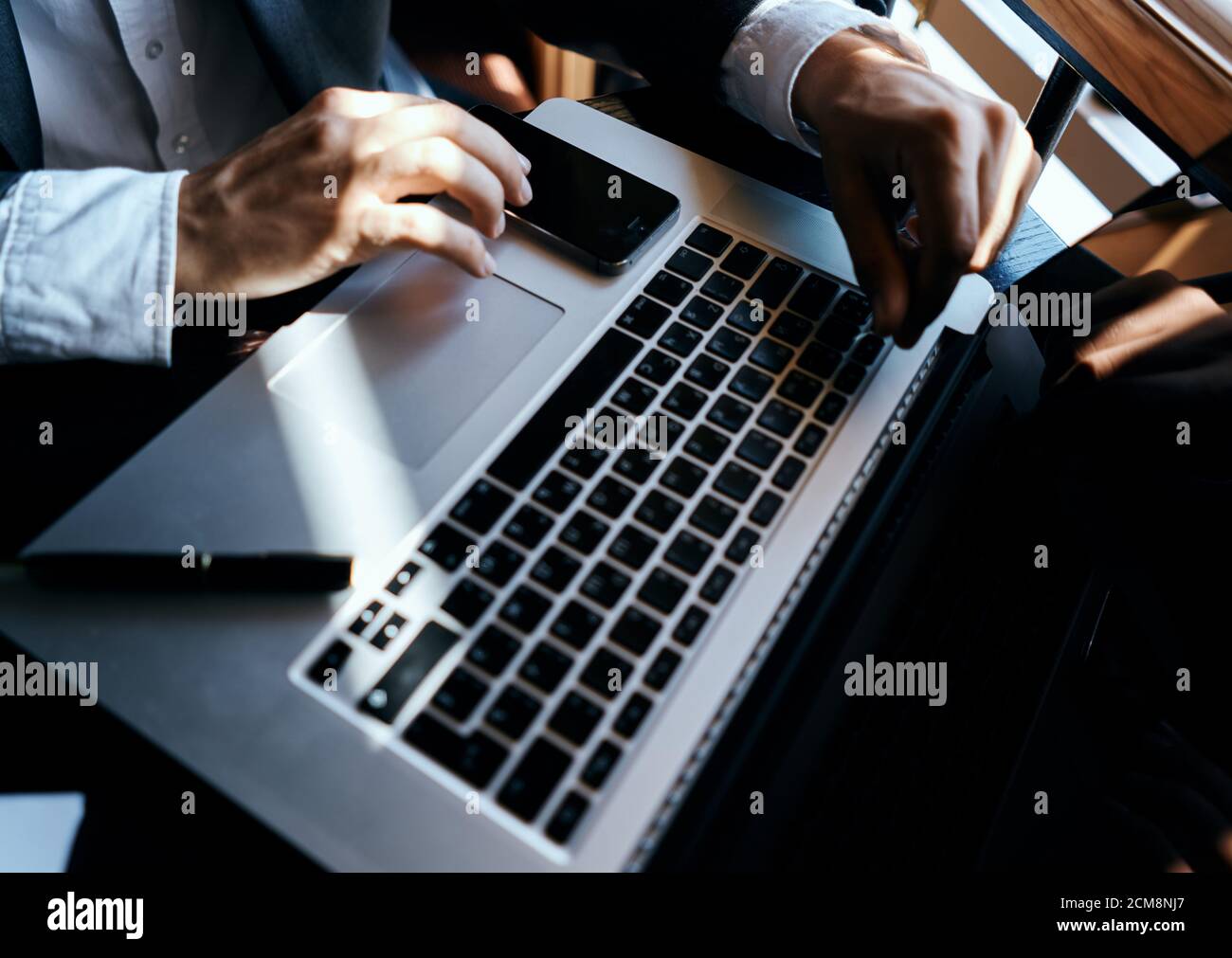 Laptop on the table businesswoman with a pen of technology ...