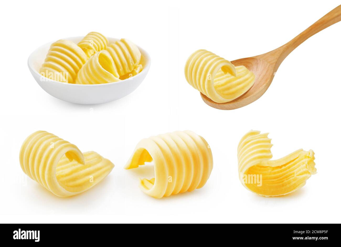 Set of butter curl on wooden spoon. Butter roll in white bowl isolated ...