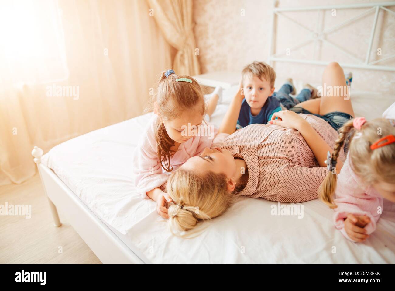 people, family and morning concept - happy child with parents waking up ...