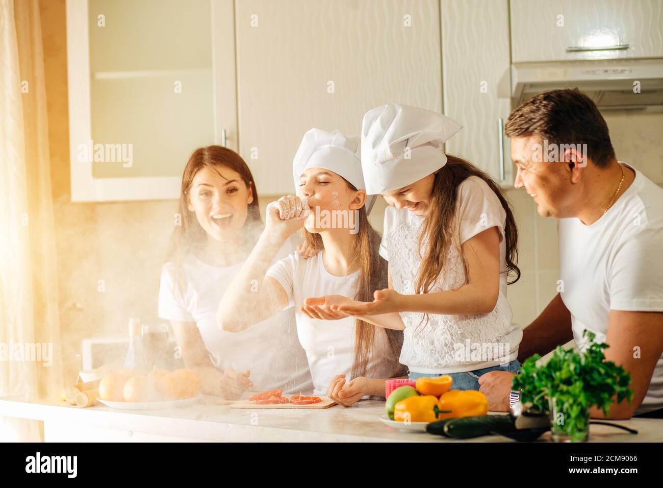 Family cooking together in modern home kitchen Stock Photo - Alamy