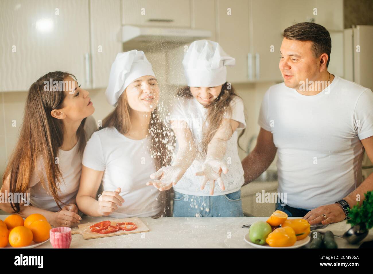 Family cooking together in modern home kitchen Stock Photo - Alamy