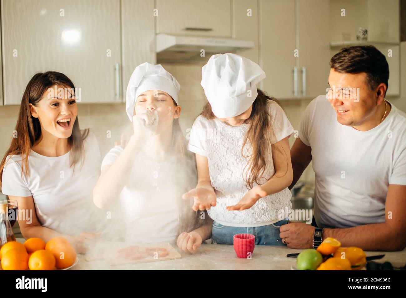 Family cooking together in modern home kitchen Stock Photo - Alamy