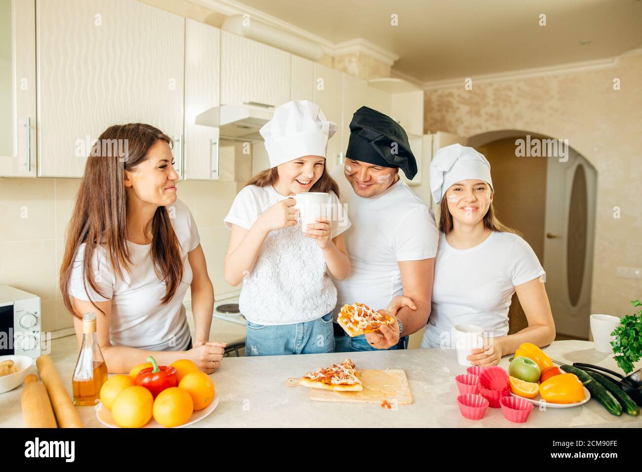 Family making pizza for dinner and eat it Stock Photo - Alamy
