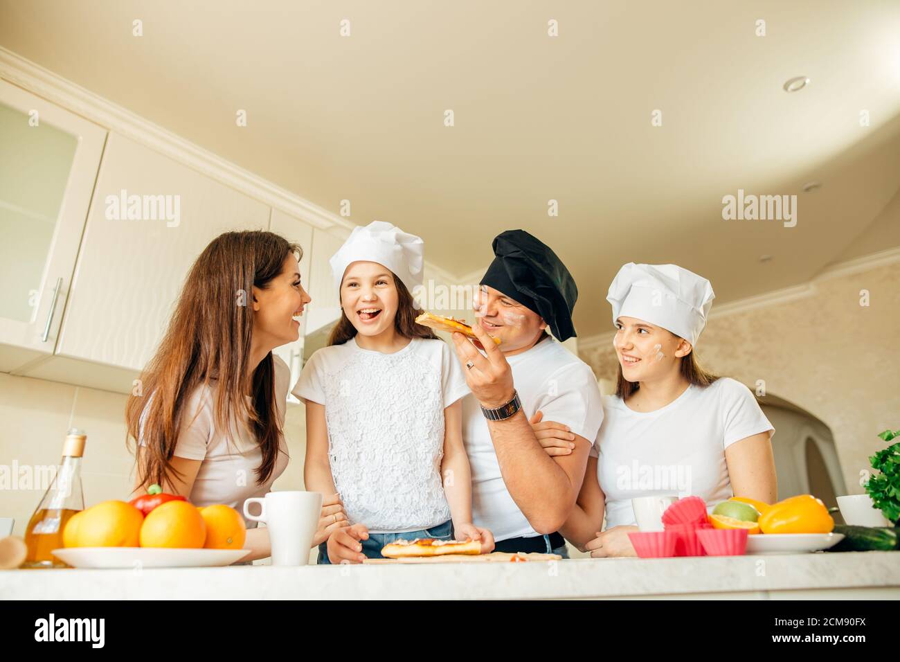 Family making pizza for dinner and eat it Stock Photo - Alamy