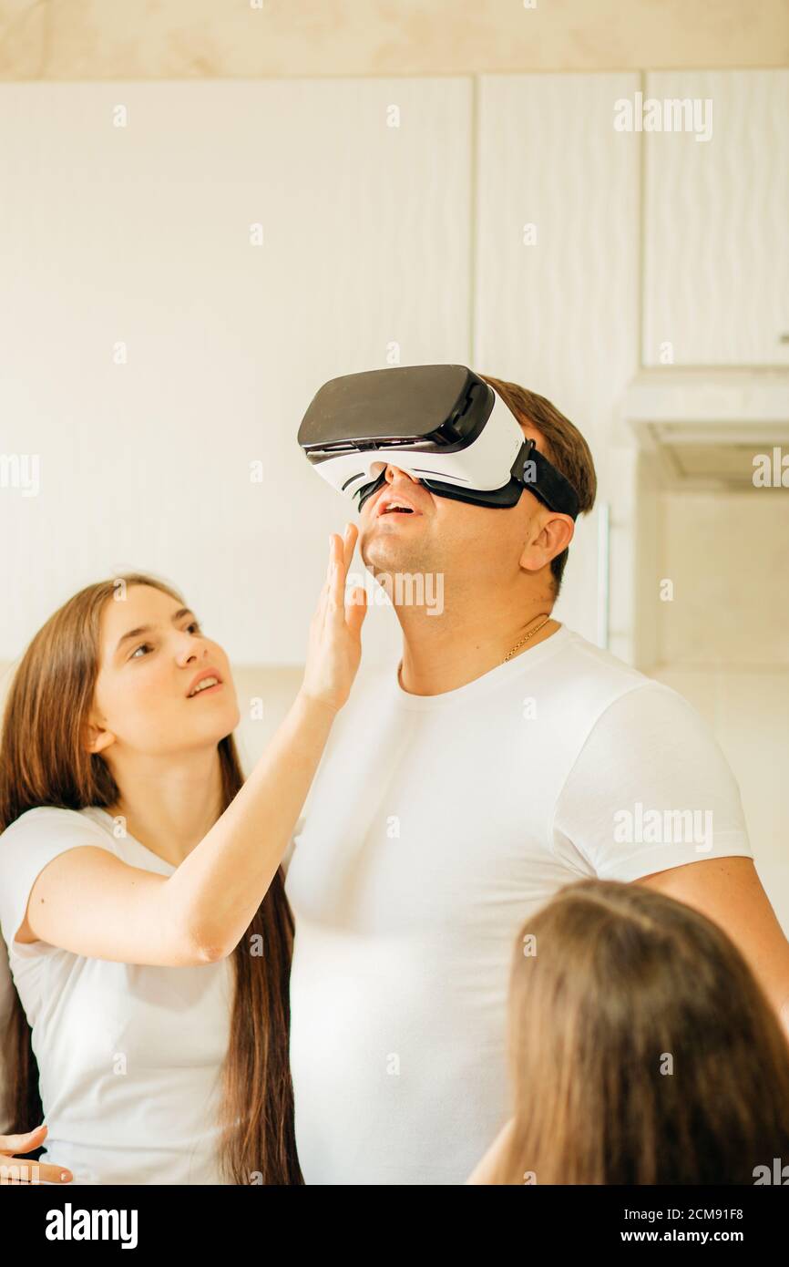 Happy family having fun together in virtual reality headsets Stock ...