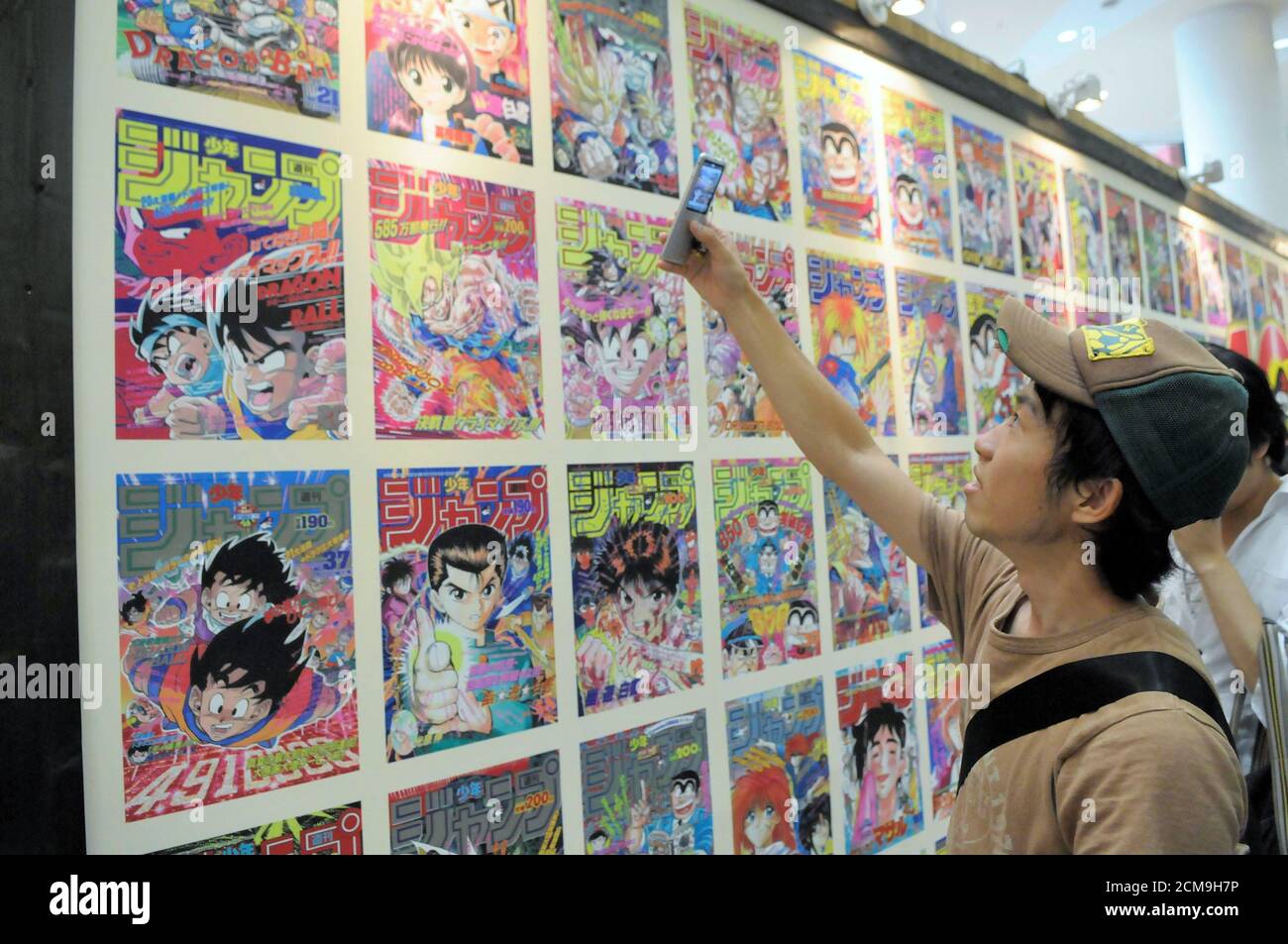YOUNG PEOPLE IN FONT OF MANGA WALL,THE TYPICAL JAPANESE COMICS Stock ...