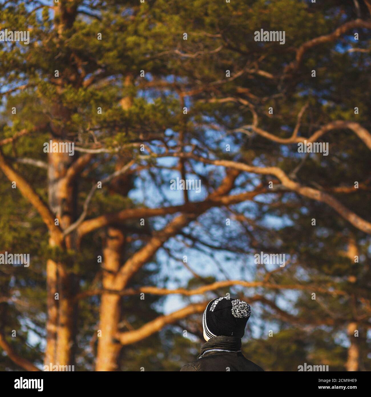 Young caucasian man in a warm winter clothes having fun in the ...