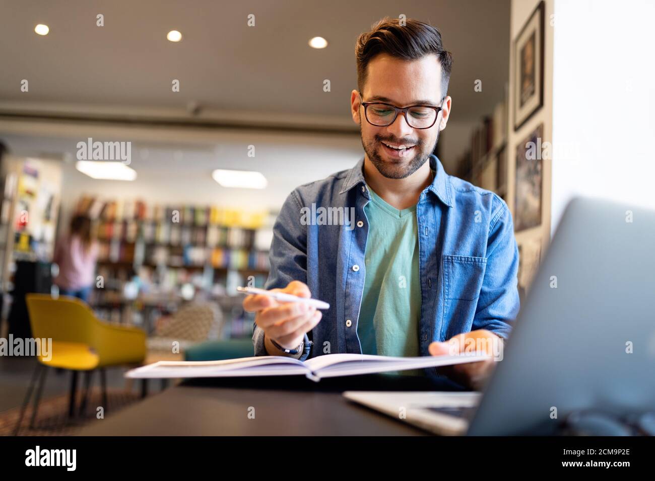 Student preparing exam and learning lessons in school library Stock ...