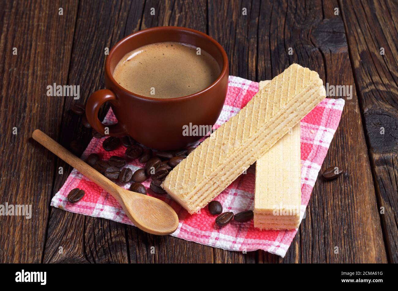 Delicious wafers and cup of hot coffee for breakfast on dark wooden ...