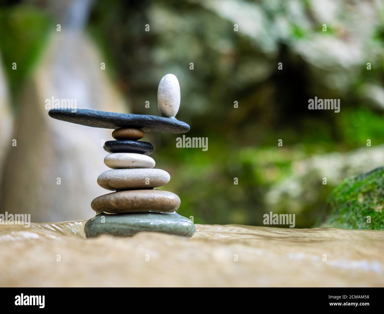 Balanced Zen stones pebbles at the waterfalls Stock Photo - Alamy