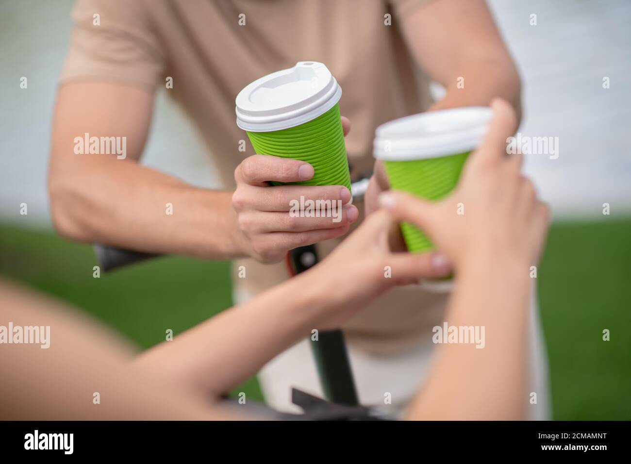 Close up picture of human hands with cups Stock Photo - Alamy