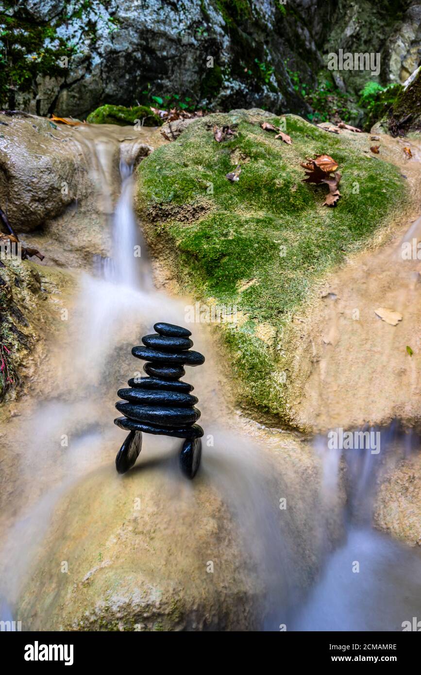 Balanced Zen stones pebbles at the waterfalls Stock Photo - Alamy