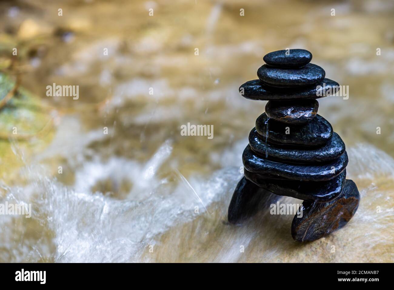 Balanced Zen stones pebbles at the waterfalls Stock Photo - Alamy