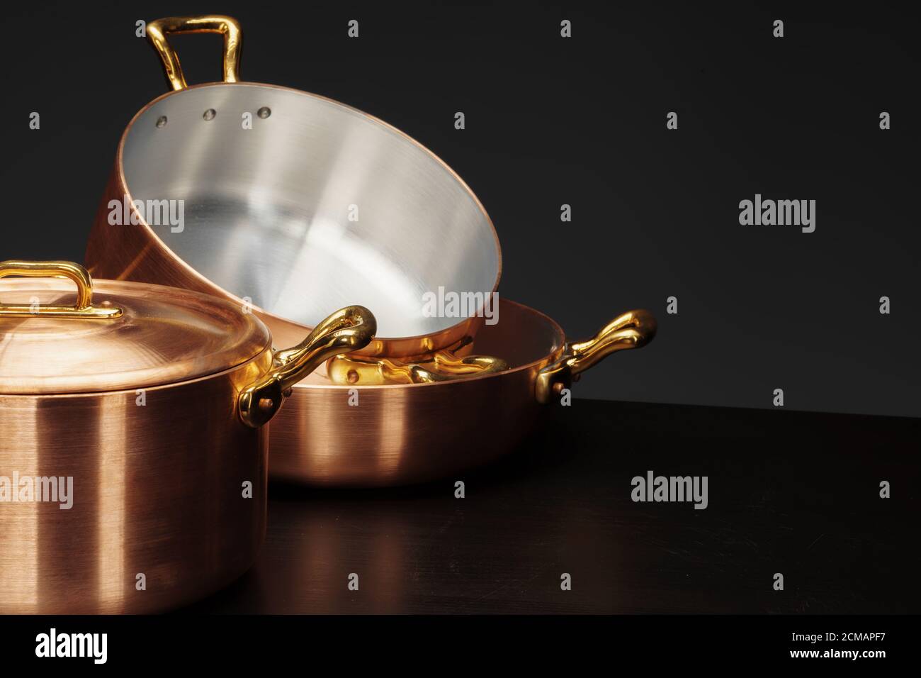 Set of copper cookware over dark background Stock Photo - Alamy