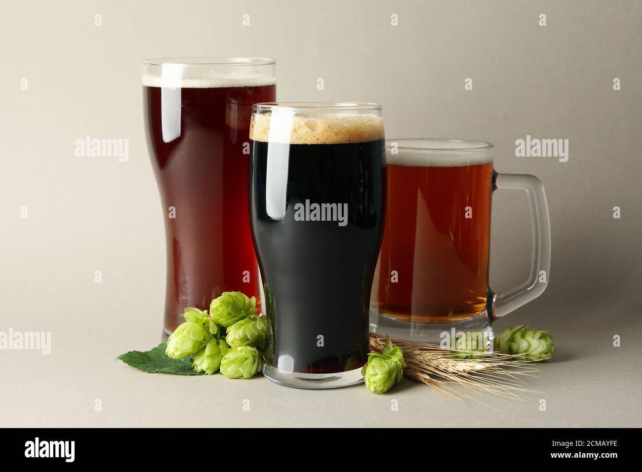 Beer and green hop on gray background Stock Photo - Alamy