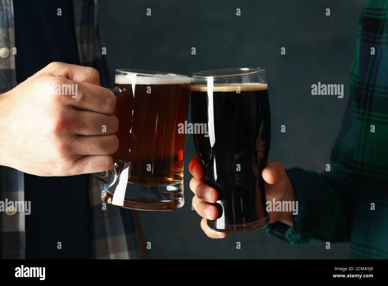 Two men in checkered shirts cheers with beer Stock Photo - Alamy