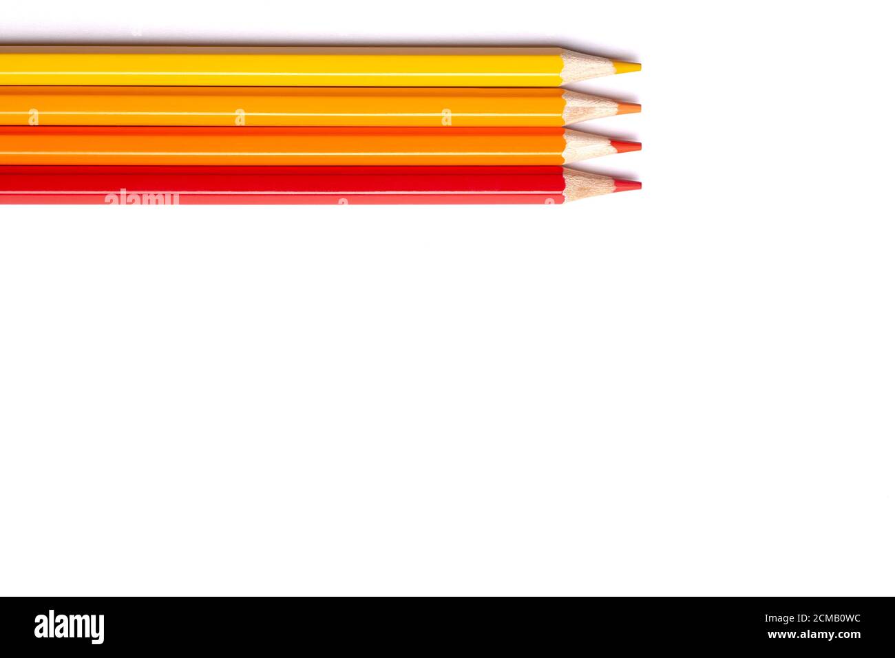 multi-colored wooden pencils in red shades on a white isolated ...