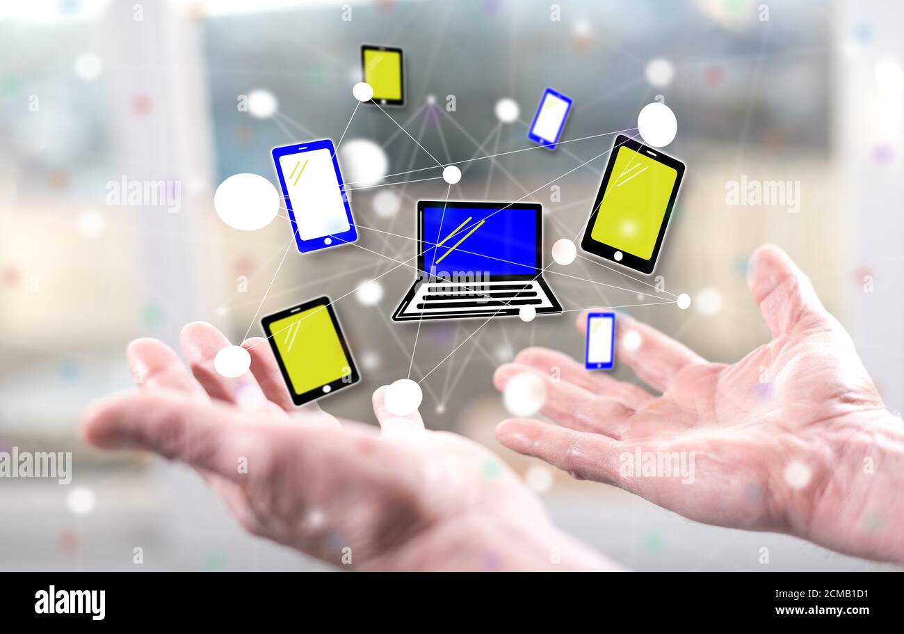 Devices connection concept above the hands of a man Stock Photo - Alamy