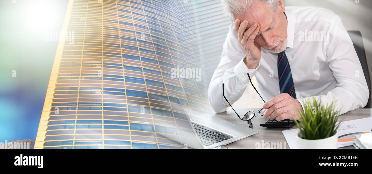Stressed businessman sitting in office with hand on forehead; multiple ...