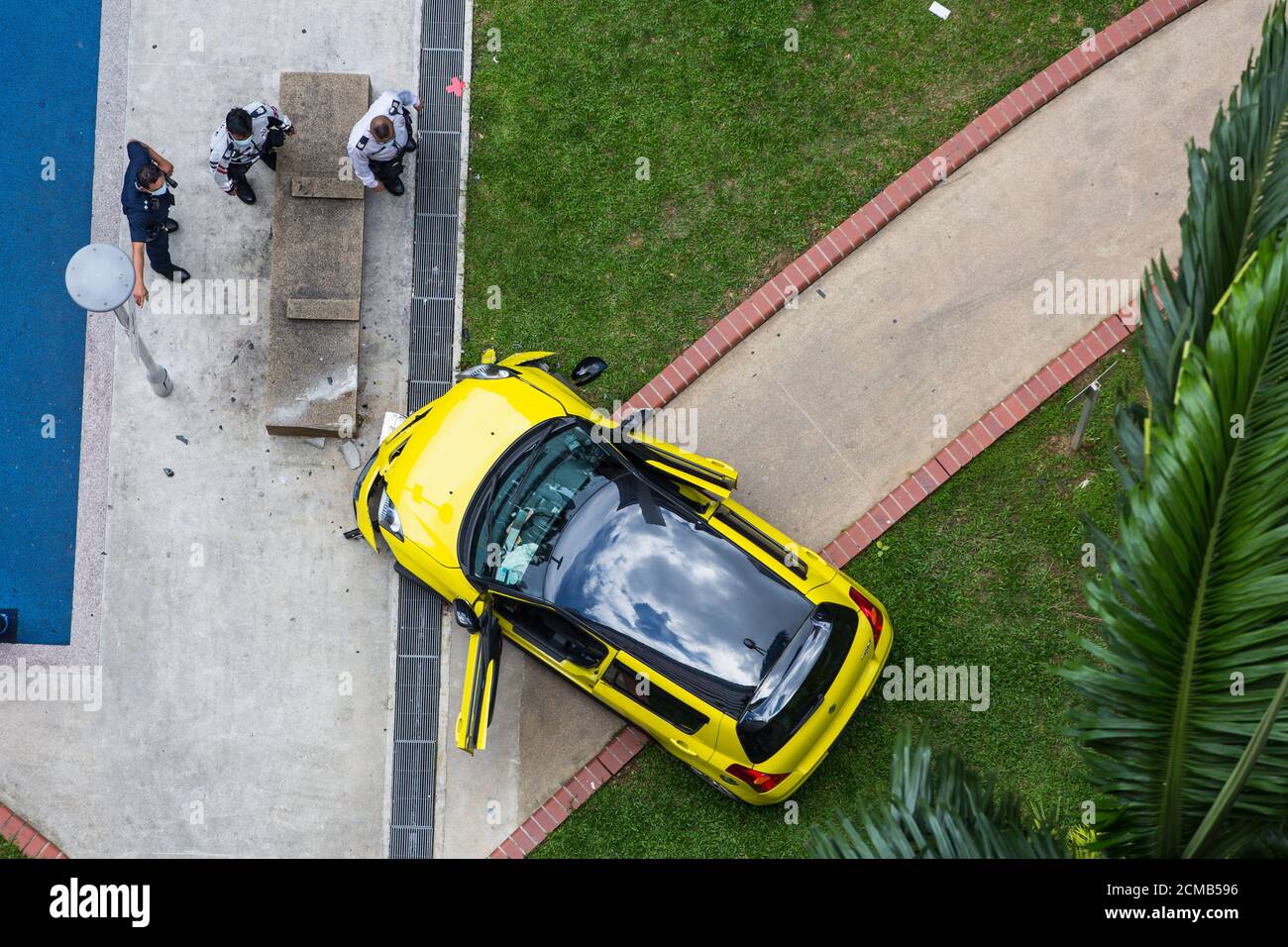 Aerial view of a yellow/black Suzuki vehicle crash onto the pedestrian ...