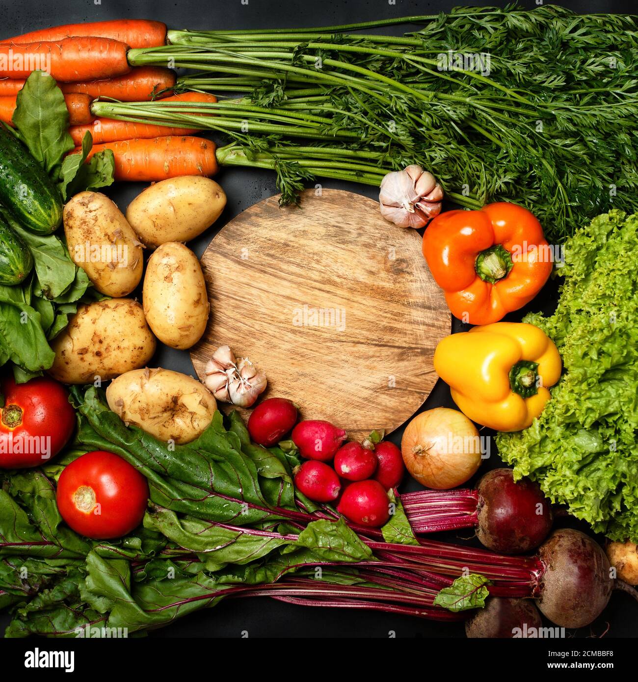 Frame made of fresh assorted vegetables on dark black background around ...