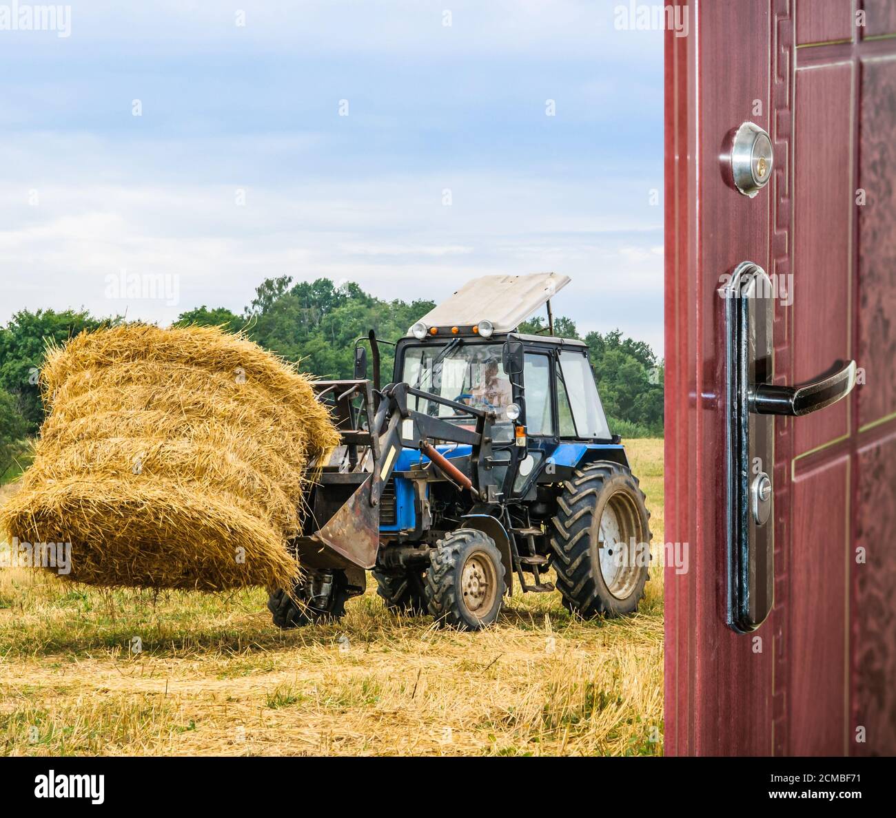 tractor with a hay Stock Photo - Alamy