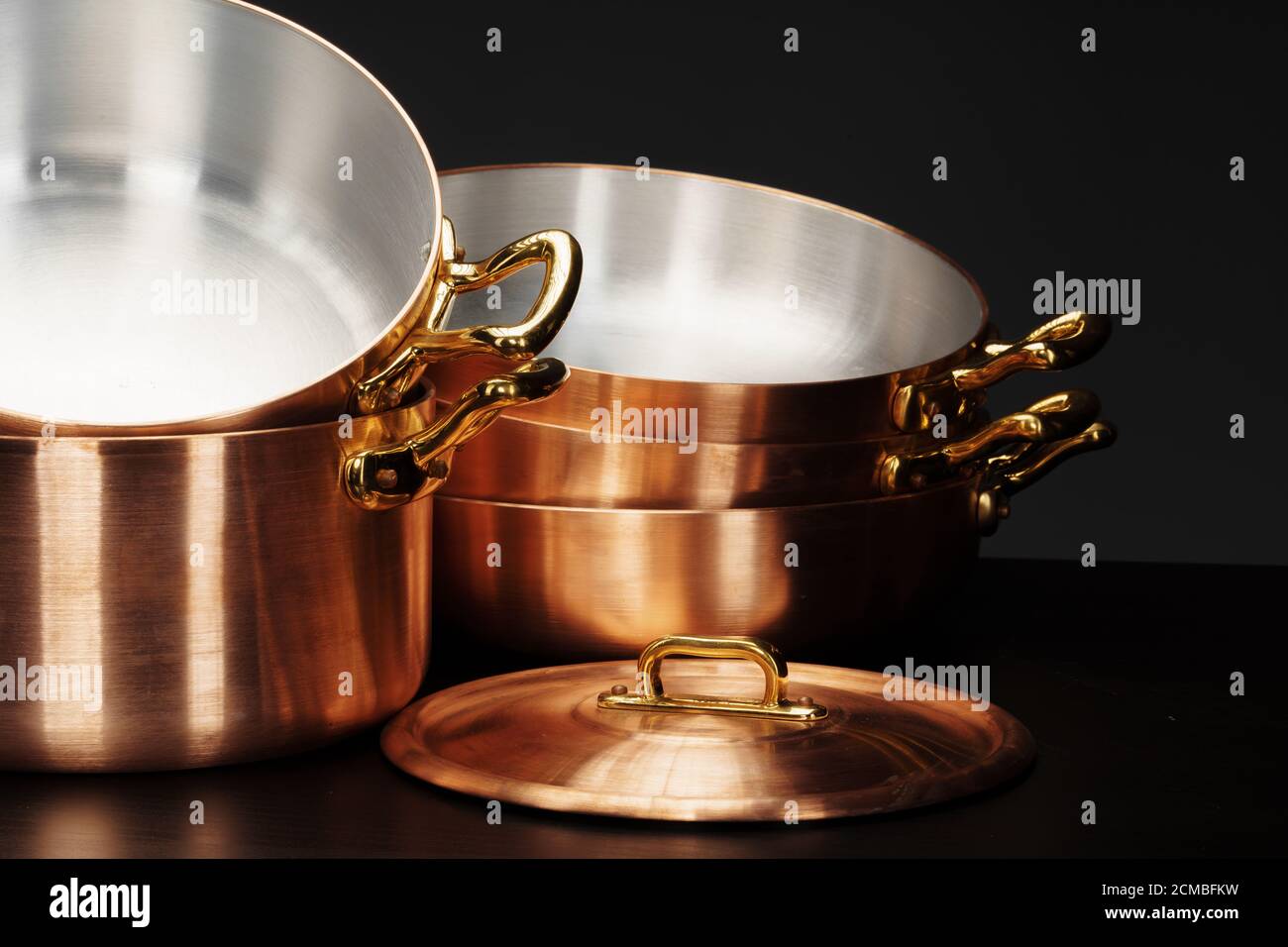Set of copper cookware over dark background Stock Photo - Alamy