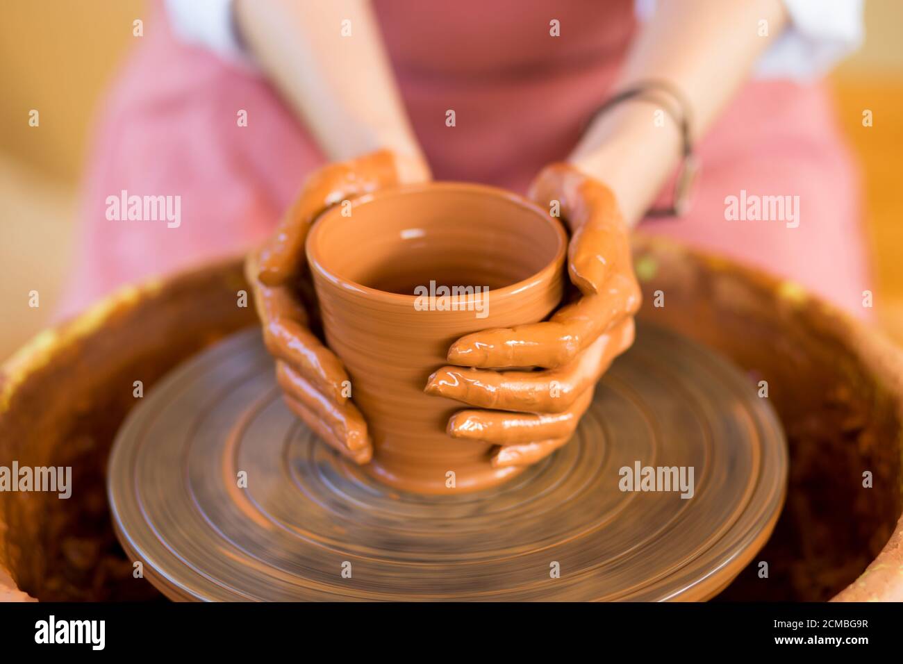 Woman hands sculpts cup from clay pot. Workshop of modeling on potter ...