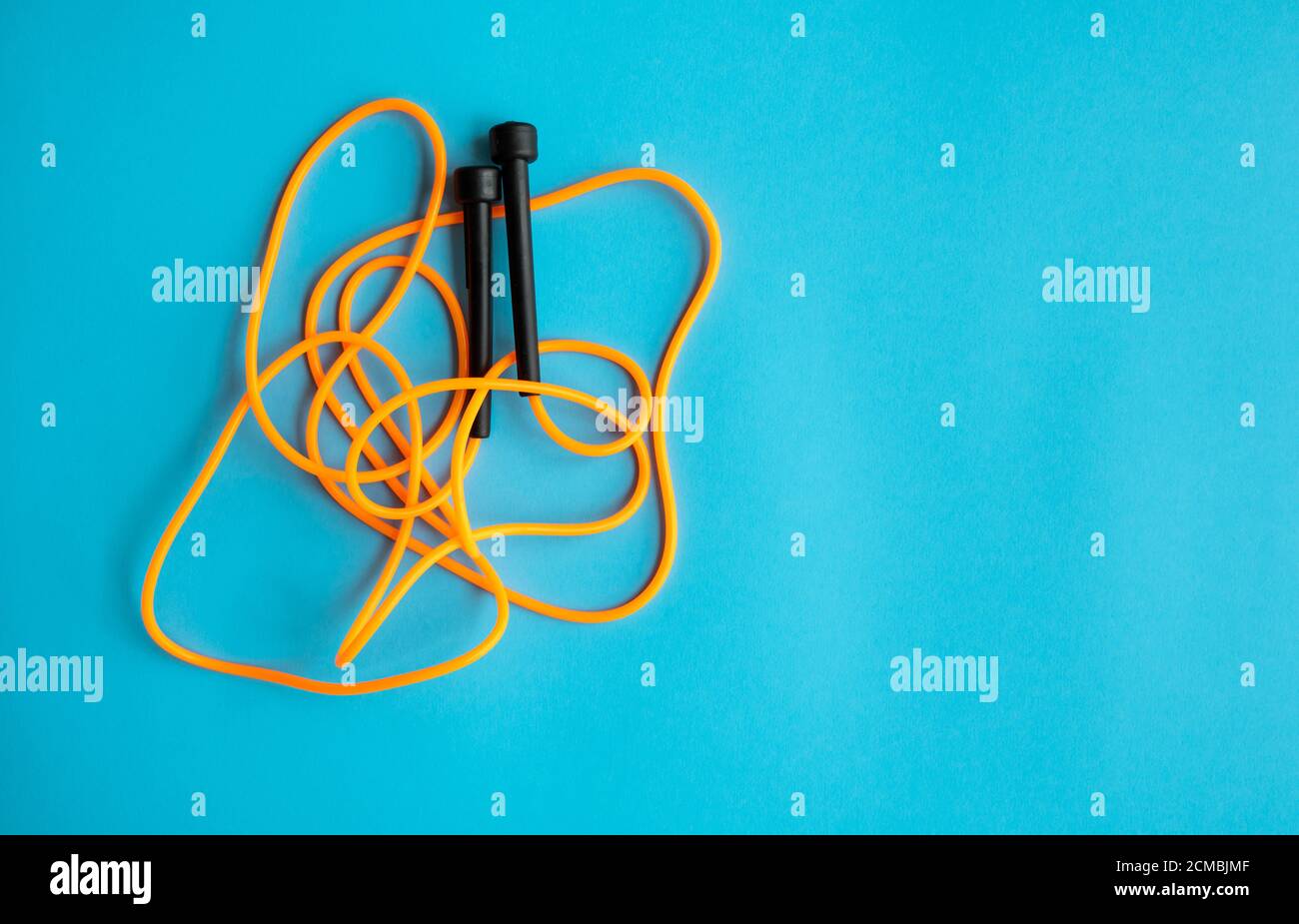 Skipping rope on blue background. Skip rope Stock Photo - Alamy