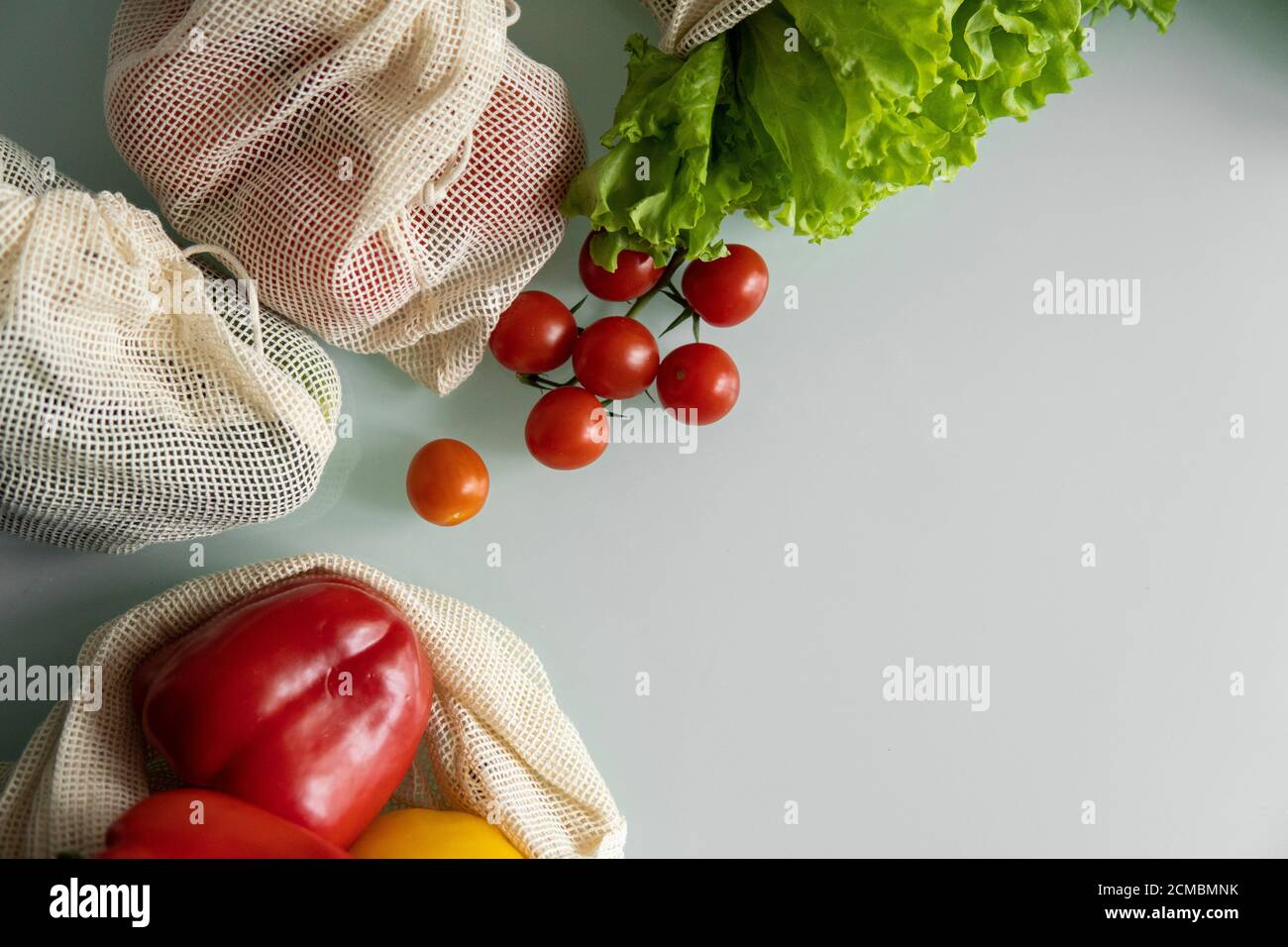 Vegetables, fruits, eggs in reusable eco cotton bags on table. Zero ...