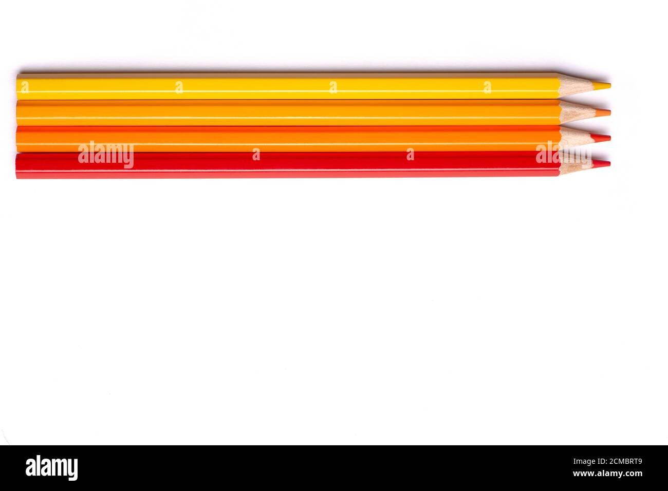 multi-colored wooden pencils in red shades on a white isolated ...