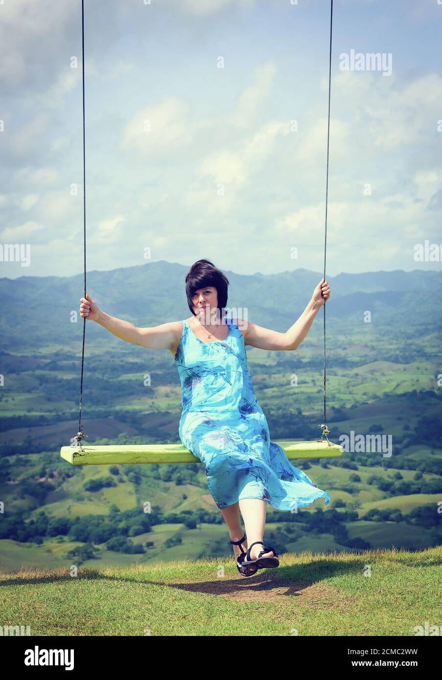 Woman swinging high Stock Photo - Alamy