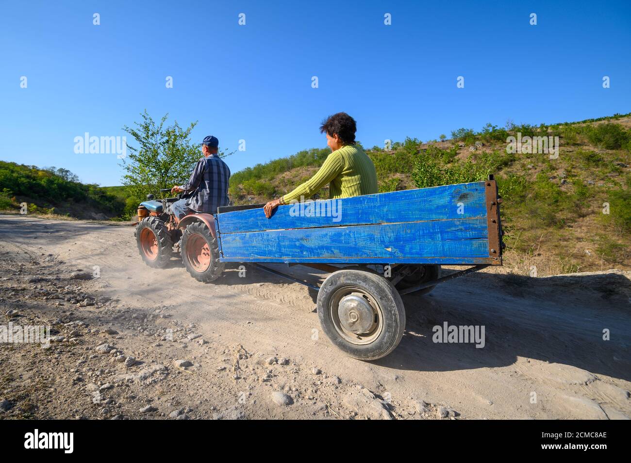 Mini tractor with passengers at dirt mountain road at Northern Moldova ...