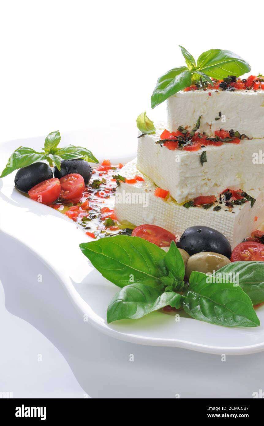 Feta cheese in oil with basil Stock Photo - Alamy