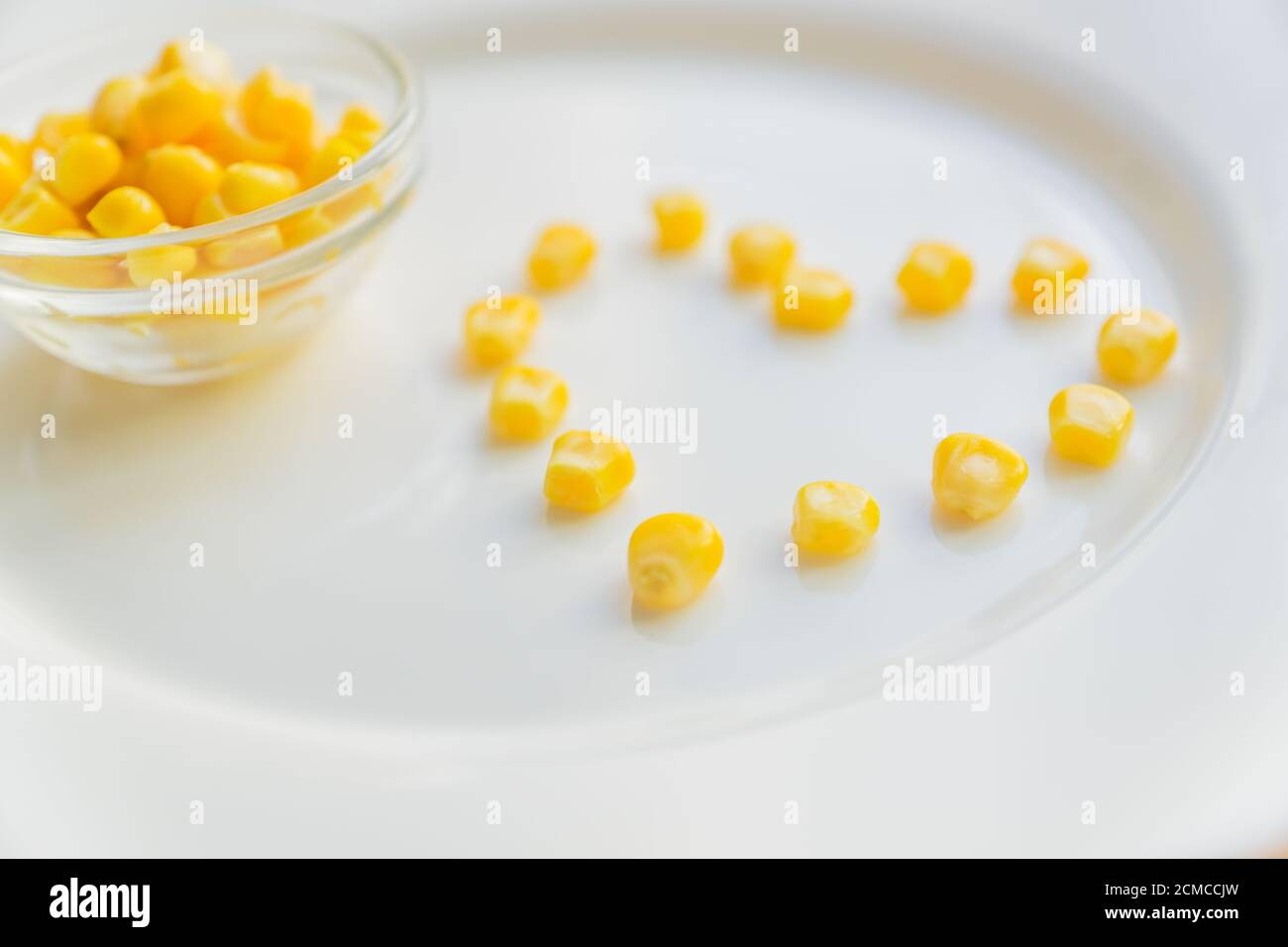 Close up of sweet corn in shape of heart on white plate Stock Photo - Alamy