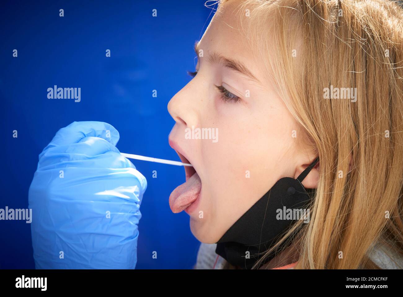 Taking a medical sample - a throat swab for a coronavirus test. Nurse ...
