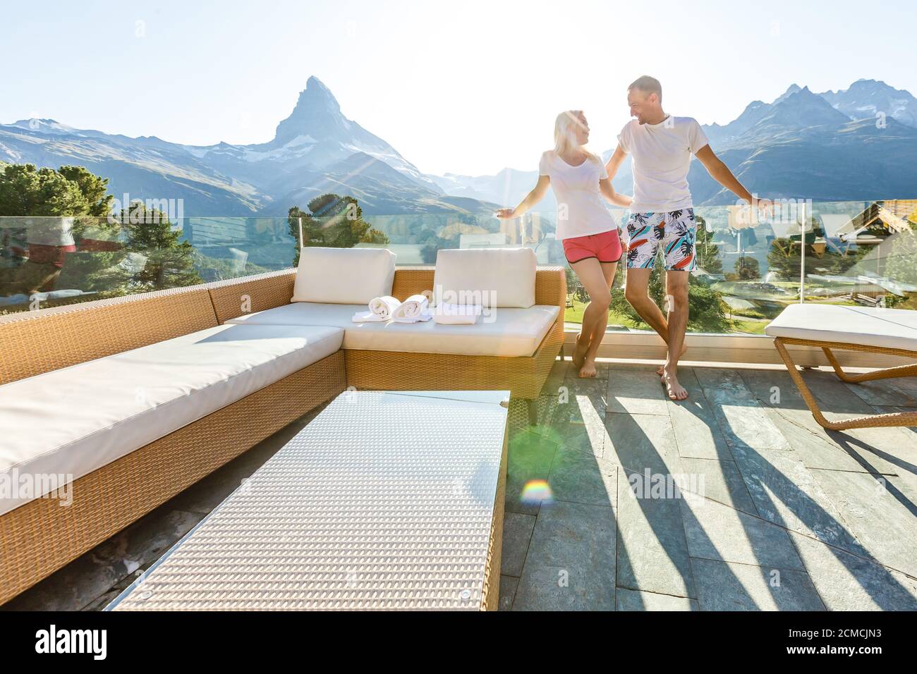Young couple - man and woman relaxing on terrace of wooden house in ...